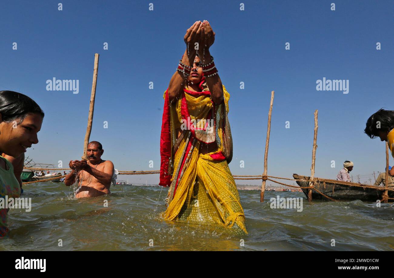 Hindu devotees offers prayers to the Sun god after taking a holy dip at ...