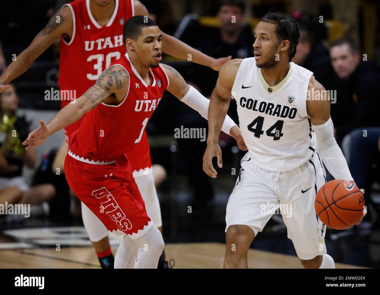 Colorado guard Josh Fortune, right, looks to pass the ball as Utah ...