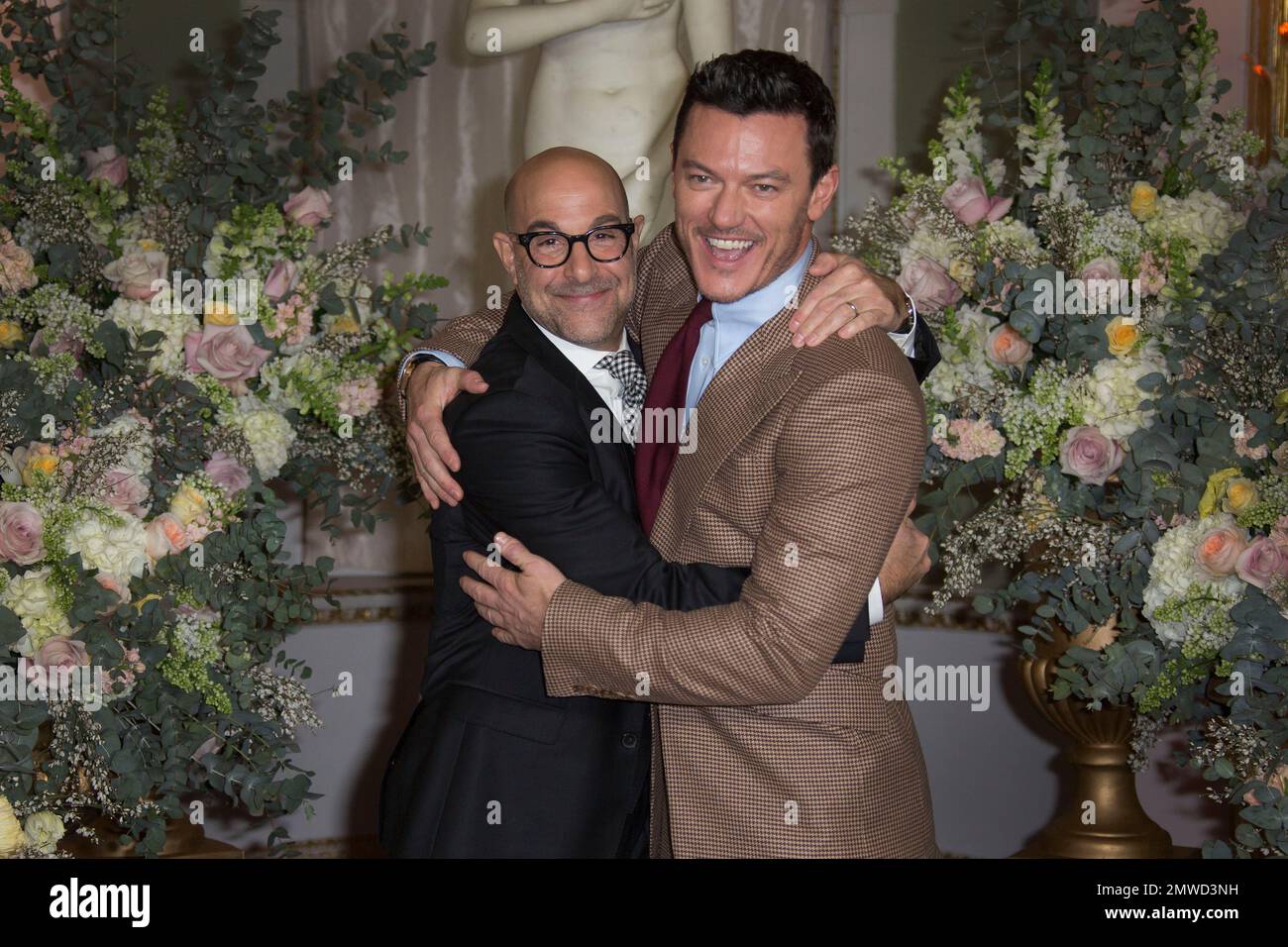 Luke Evans and Stanley Tucci hug as they pose for photographers ahead ...