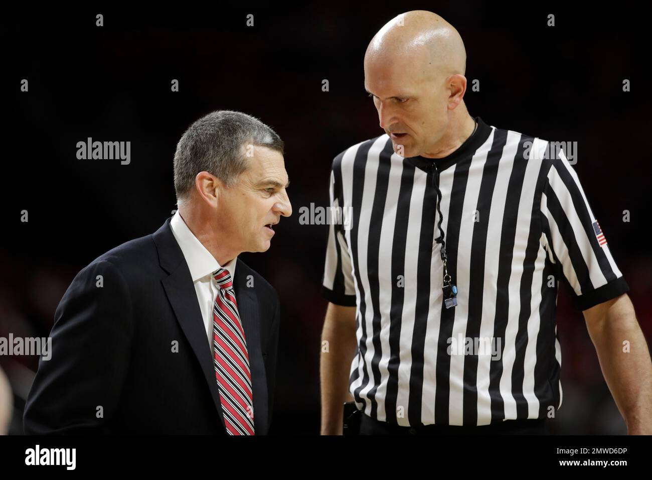 Maryland head coach Mark Turgeon, left, speaks with an official during ...