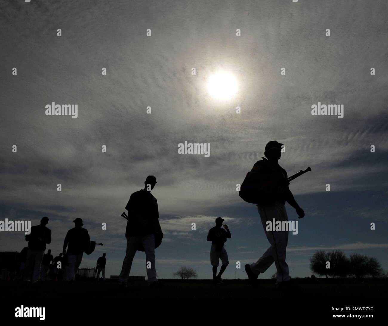 Players for the Texas Rangers walk to a practice field during spring ...
