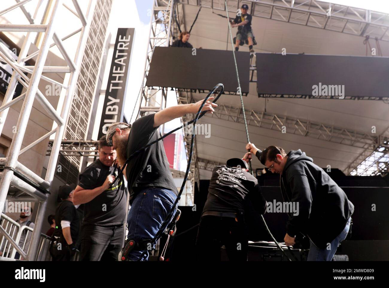 Workers hoist a screen as preparations are made for the 89th Academy ...
