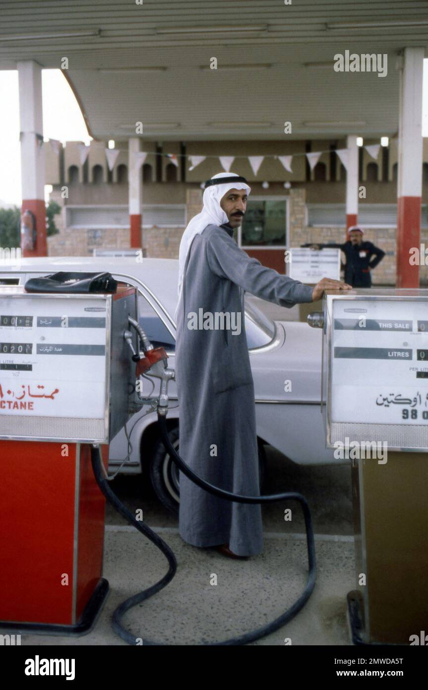 A local gas station attendant pumps gas in the oil rich capital of ...