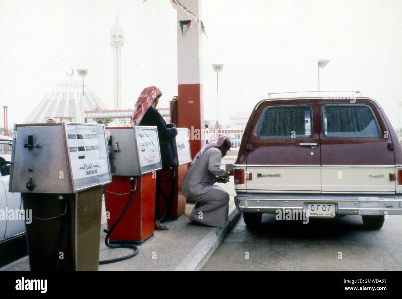 A local gas station attendant pumps gas in the oil rich capital of ...