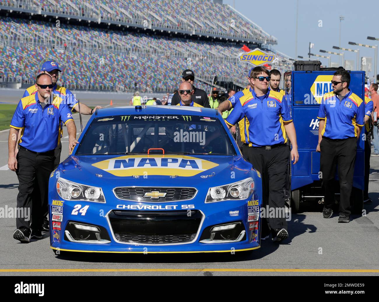 Crew members for Chase Elliott push his race car on pit road before ...