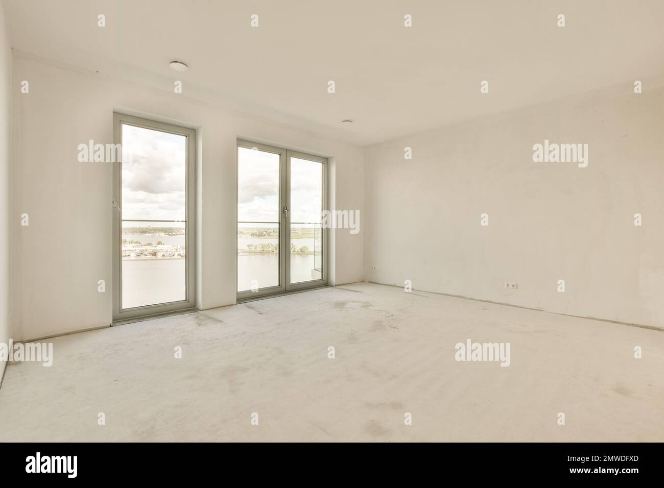 an empty room with large windows and no people in the room to see what ...