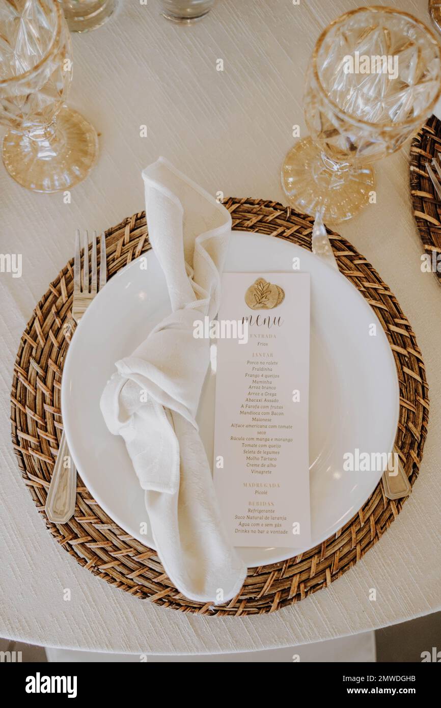 A vertical top view of a custom small menu on a plate with a folded ...