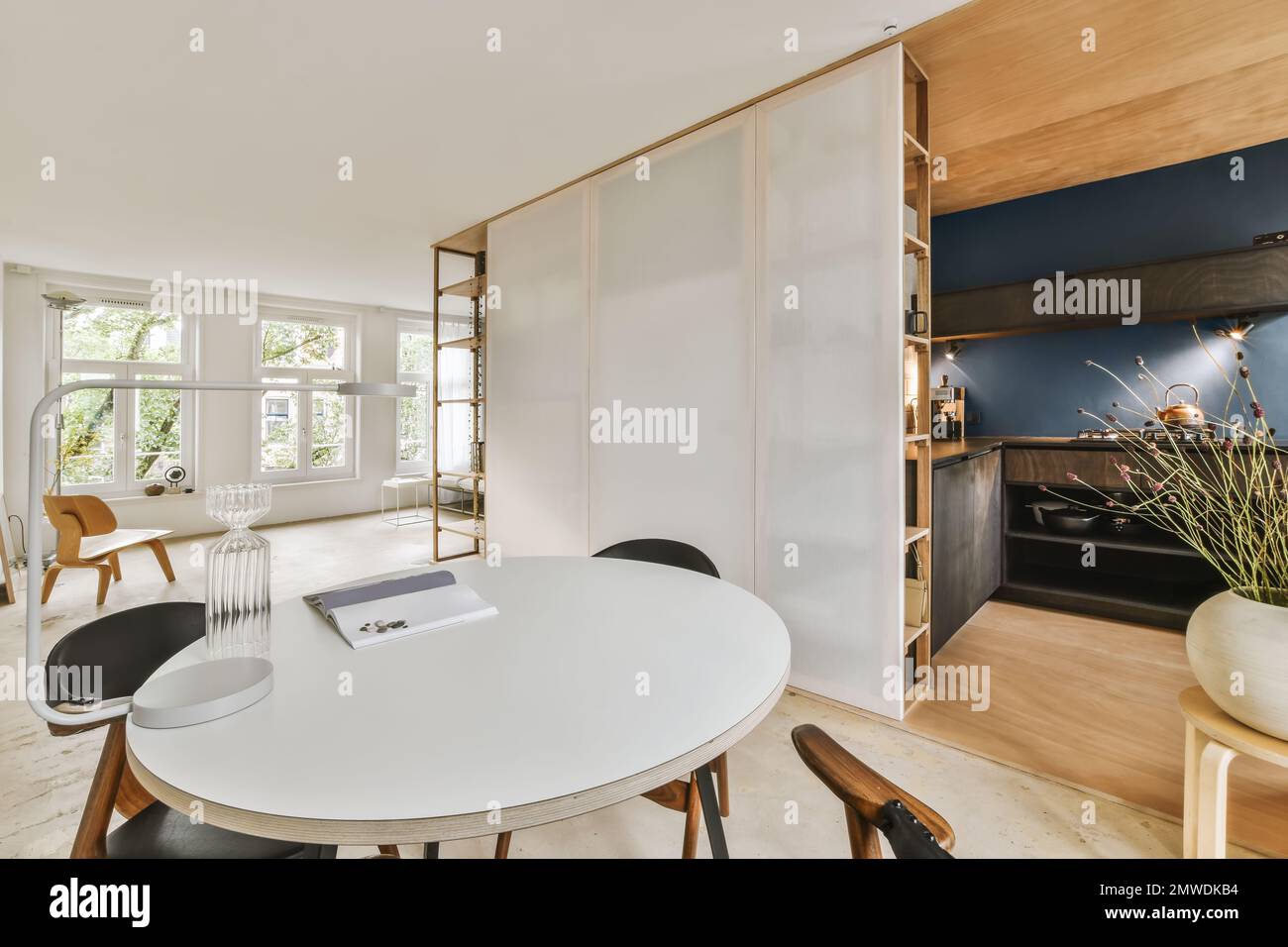 a dining room with a table and chairs in front of an open door that ...