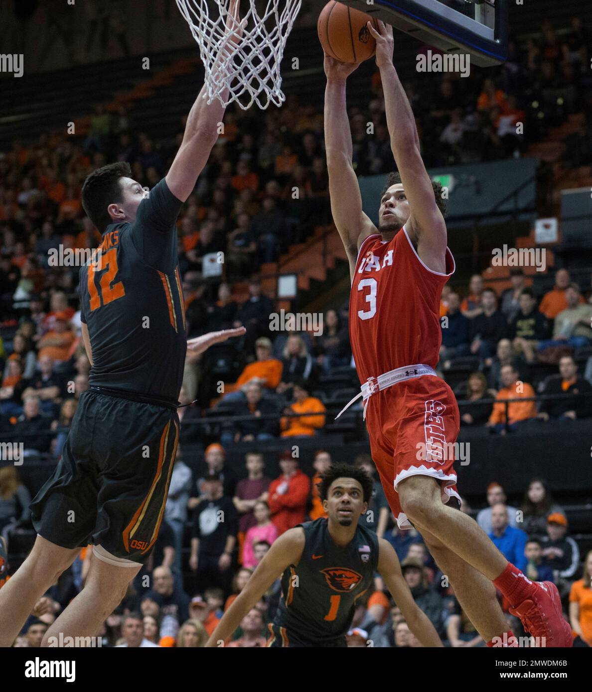 Oregon State's Drew Eubanks (12) contests the shot of Utah's Devon ...