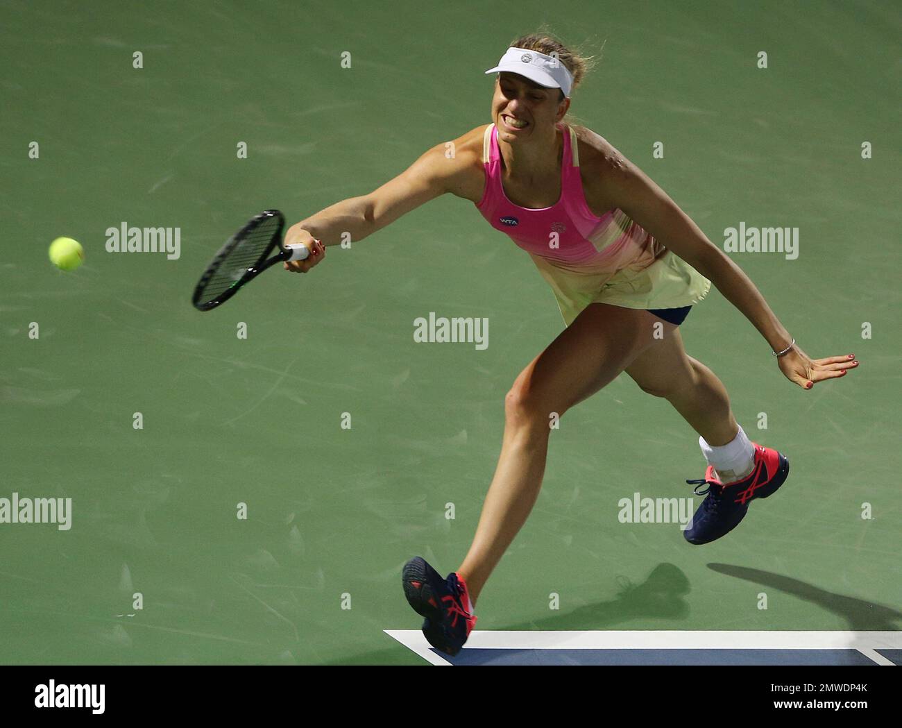 Mona Barthel of Germany returns the ball to Jelena Jankovic of Serbia ...