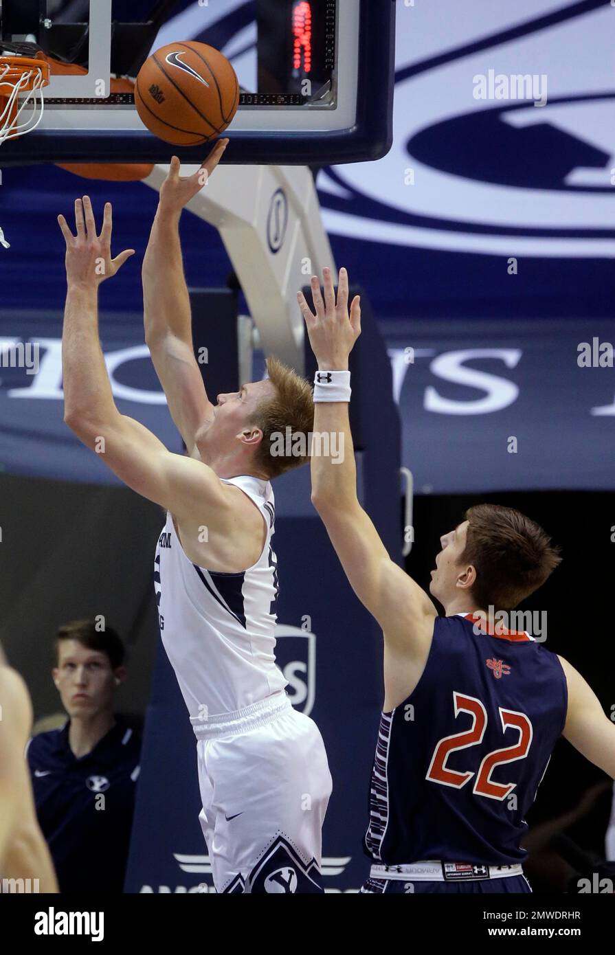 BYU forward Eric Mika, left, shoots as St. Mary's forward Dane Pineau ...