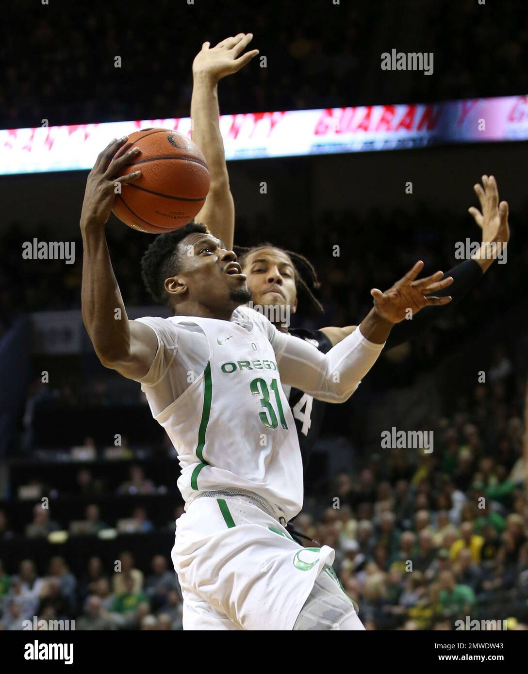 Oregon's Dylan Ennis, left, goes to the basket against Colorado's Josh ...