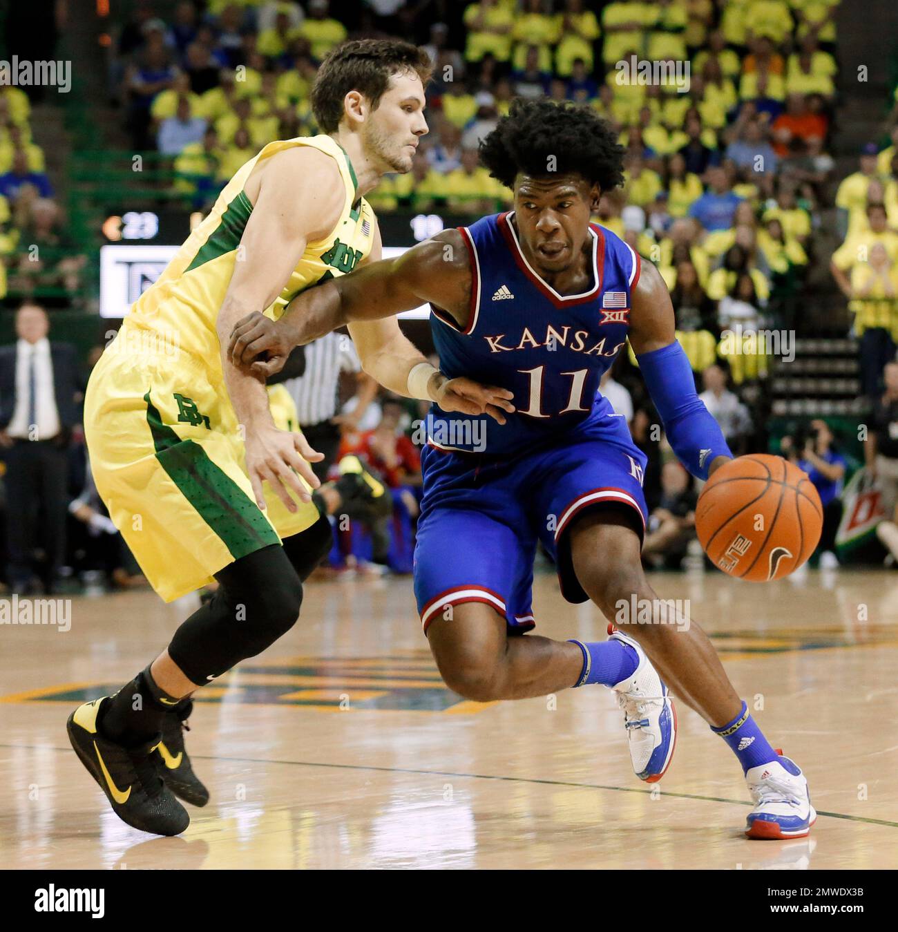 Baylor's Jake Lindsey, left, defends as Baylor's Mark Vital (11) moves ...