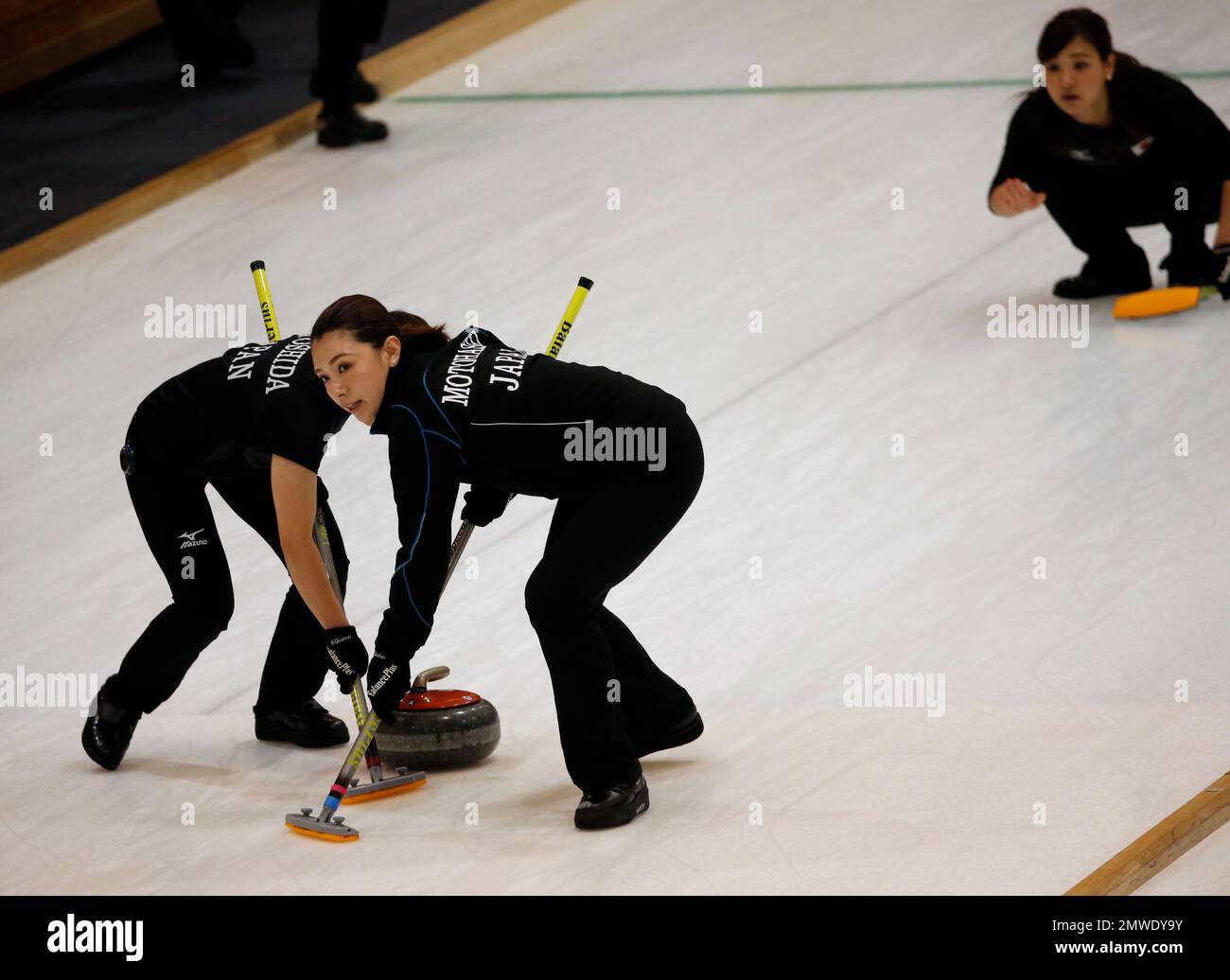Japan's Mari Motohashi, bottom right, and Chinami Yoshida sweep the ice ...
