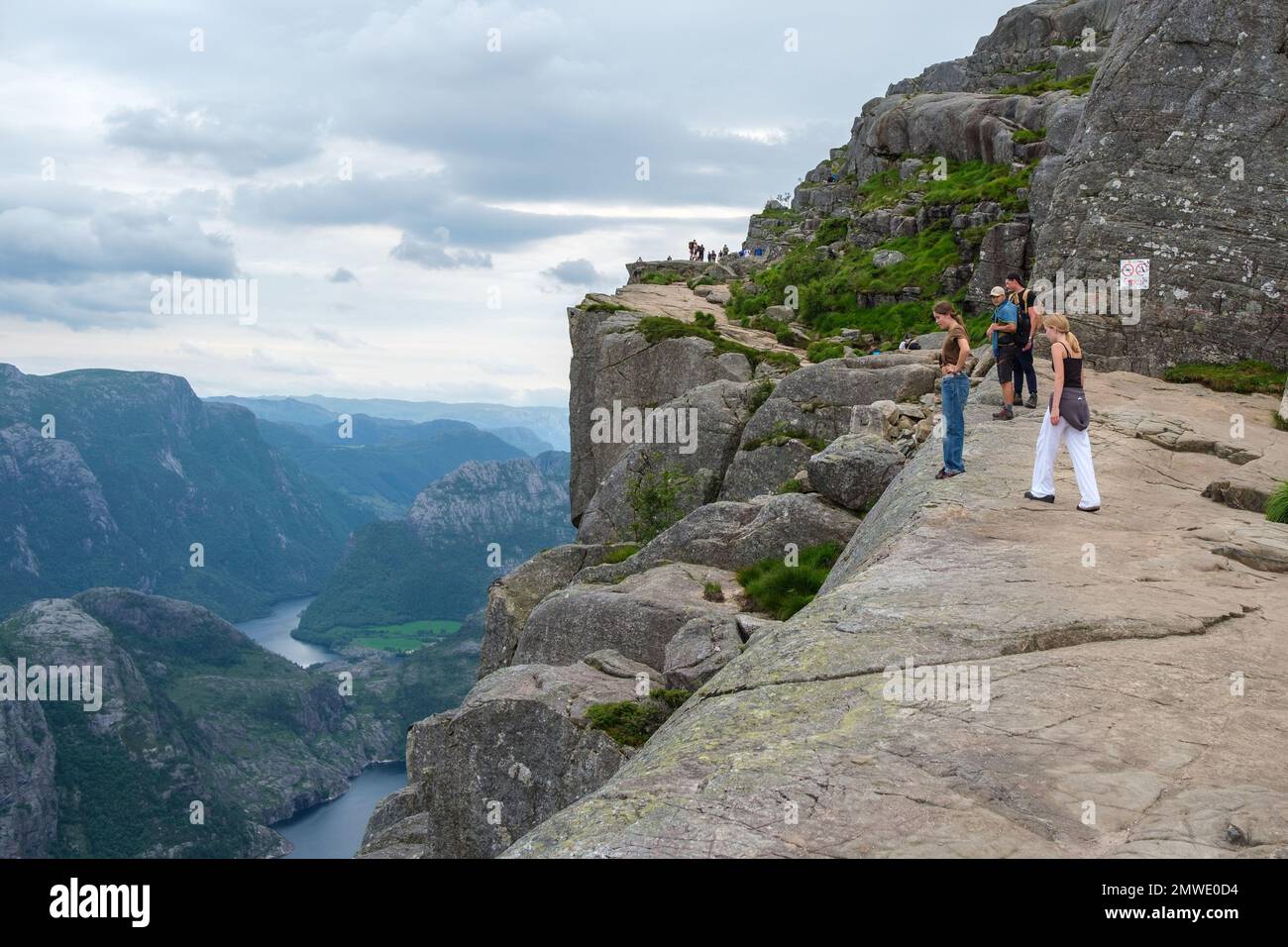 A group of people enjoying the view from the Preikestolen cliff in ...