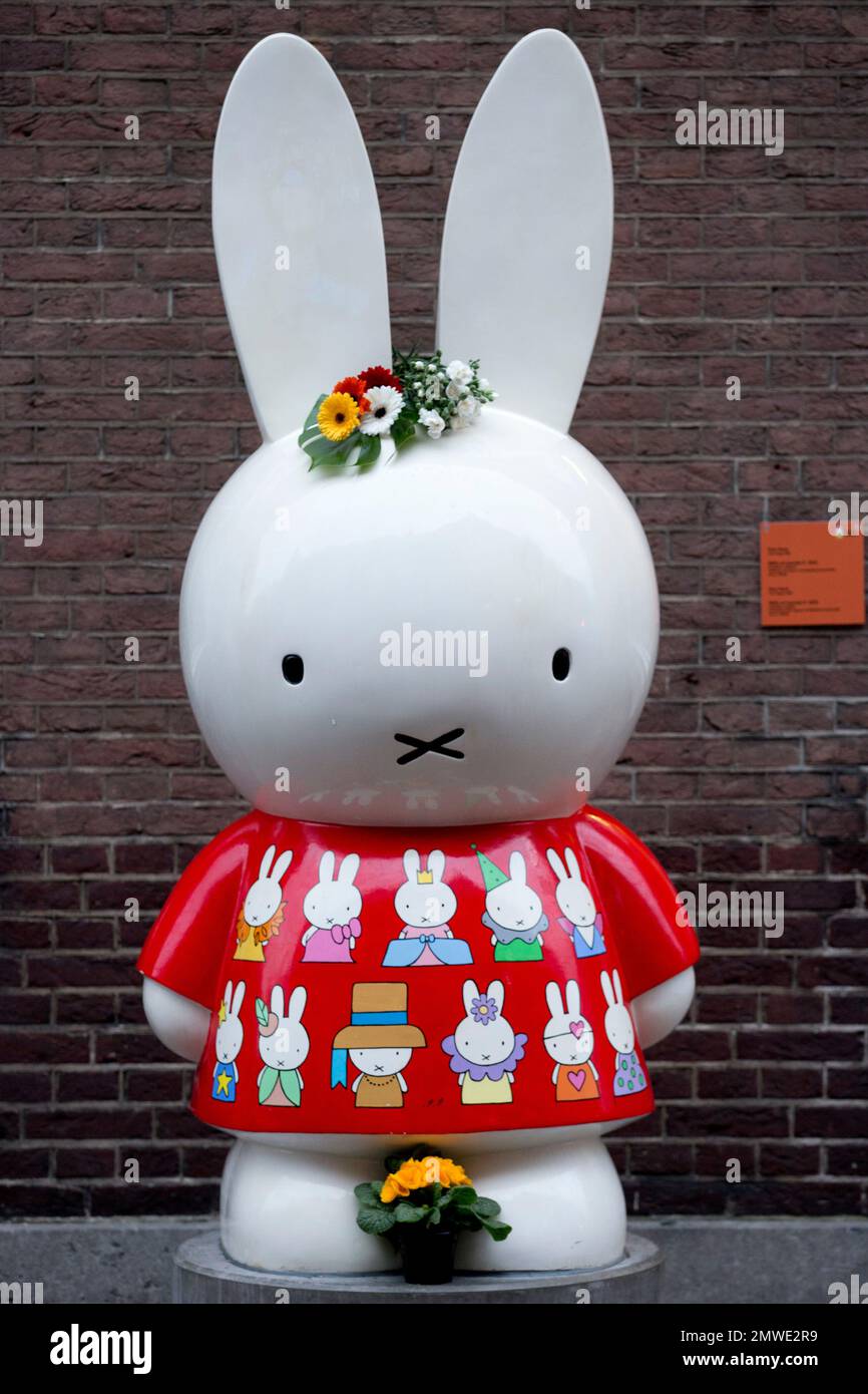 A statue of Miffy adorned with flowers stands outside the Nijntje ...