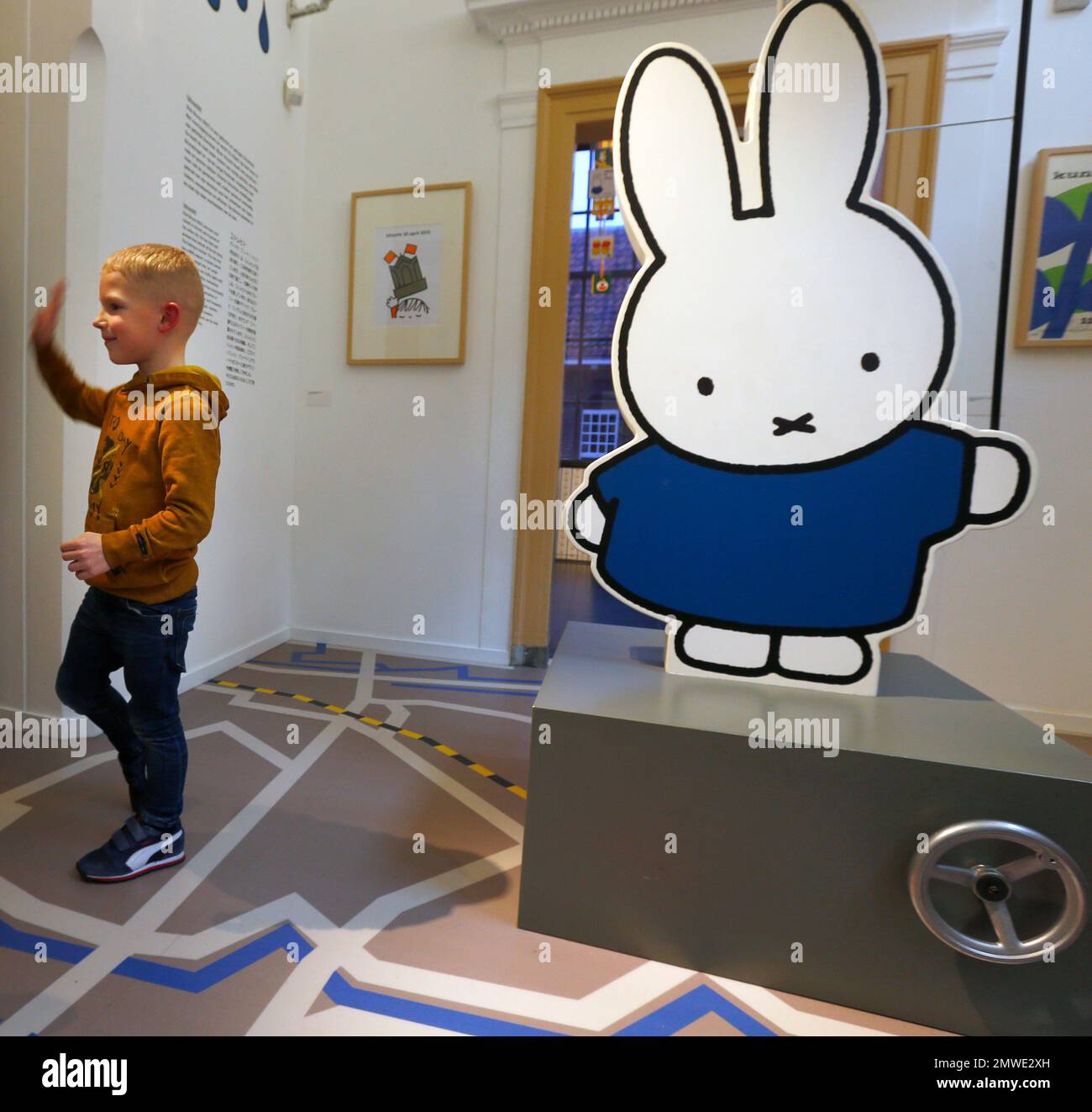 A child waves goodbye to a TV camera as he visits the Nijntje Museum ...