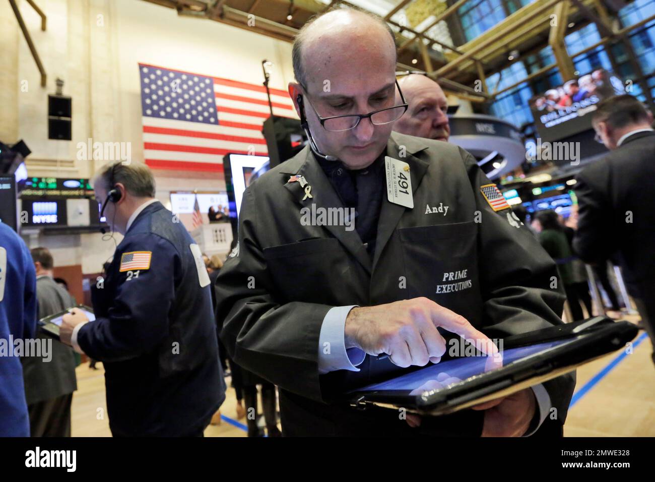 Trader Andrew Silverman, center, works on the floor of the New York ...