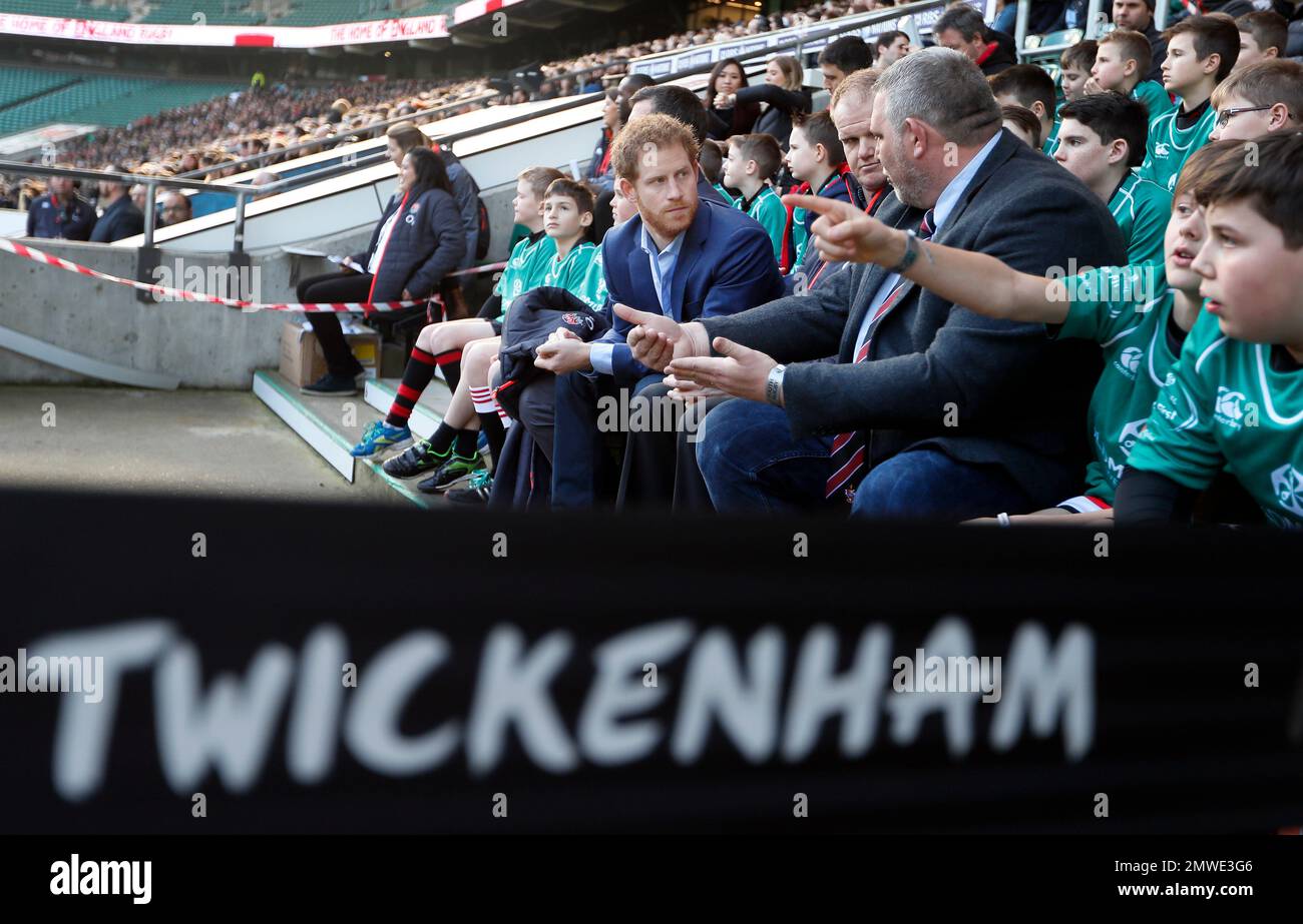 Britain's Prince Harry, centre, speaks with people from the Kids First ...