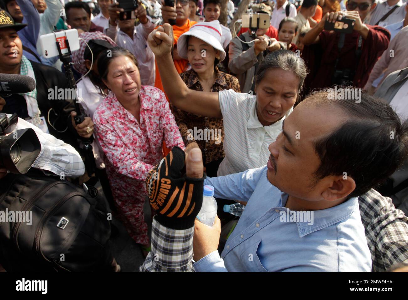 Political commentator Kim Sok, right, is greeted by his supporters as ...