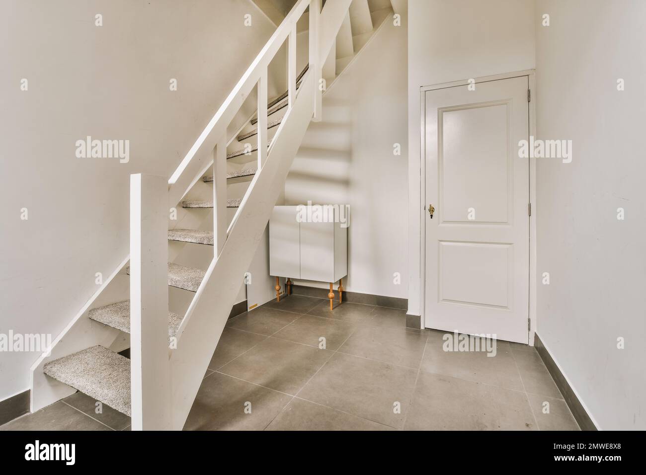 an empty room with some stairs and a mirror on the wall in front of the ...