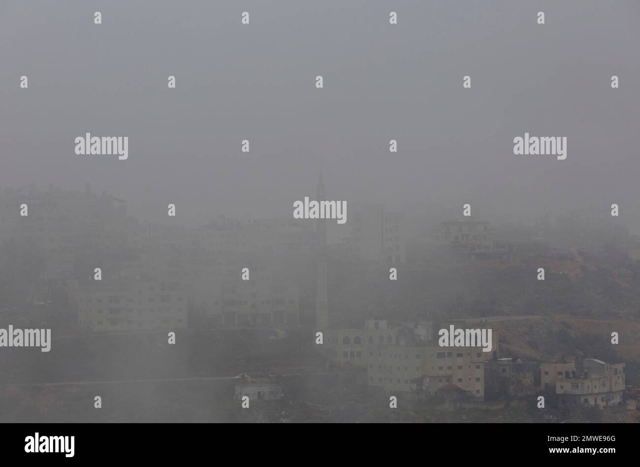 A mosque in seen through the thick fog during a heavy rain storm in the ...