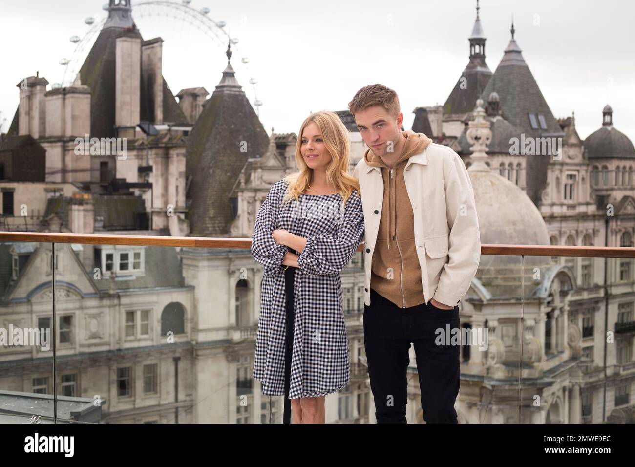 Actors, from left, Sienna Miller, and Robert Pattinson, pose for ...