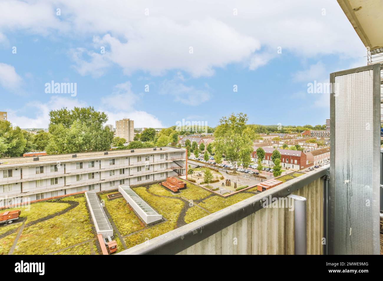 a green roof on a building in portland, oregon with blue sky and white ...