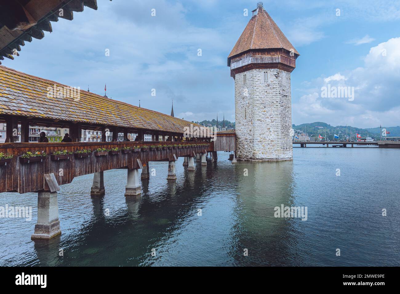 The Chapel Bridge, a covered wooden footbridge spanning the river Reuss ...