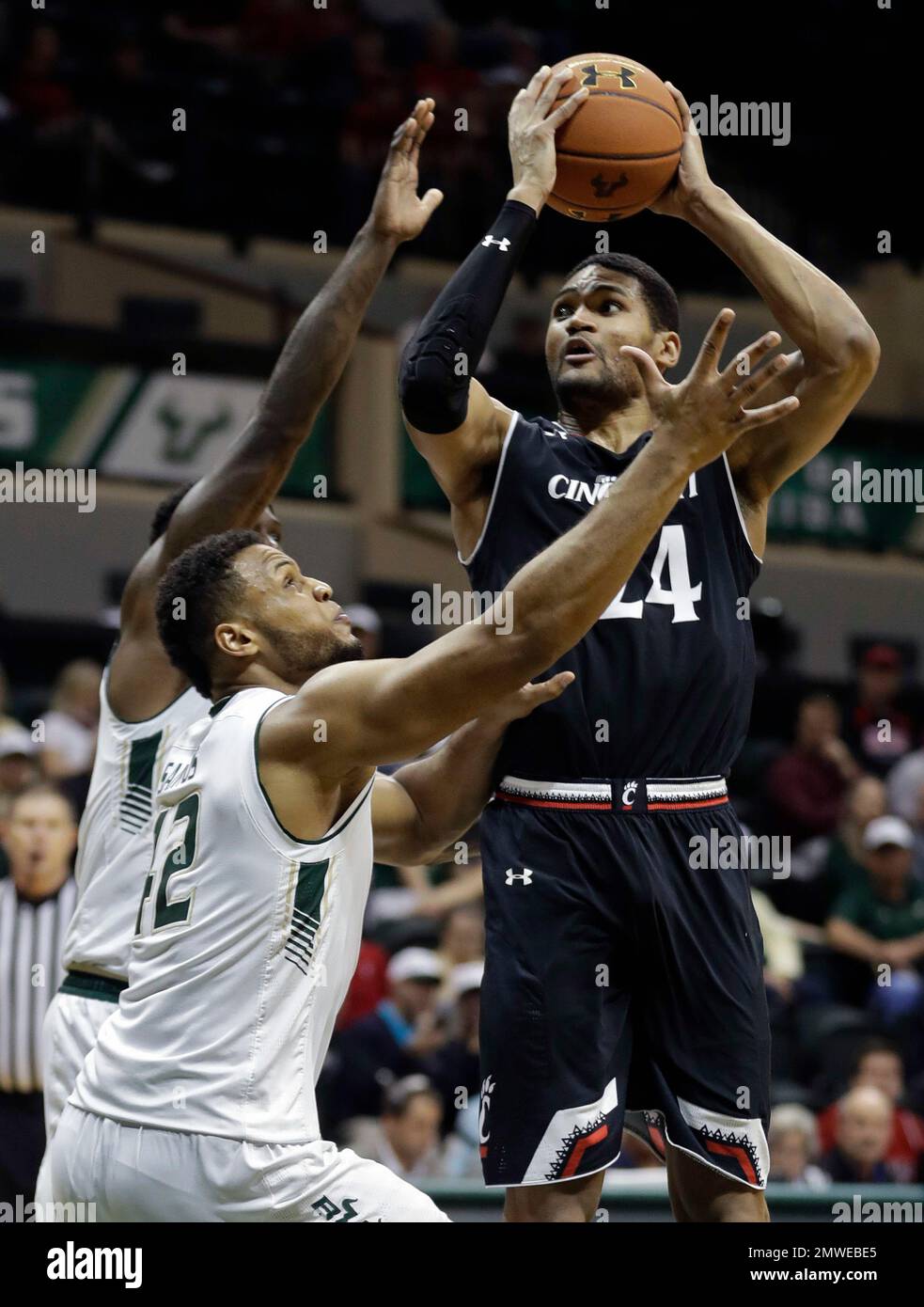 Cincinnati forward Kyle Washington (24) grabs a rebound over South ...
