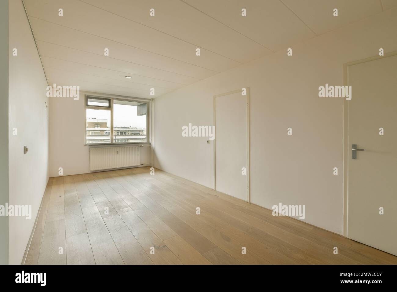 an empty room with white walls and wood flooring on the right side of ...
