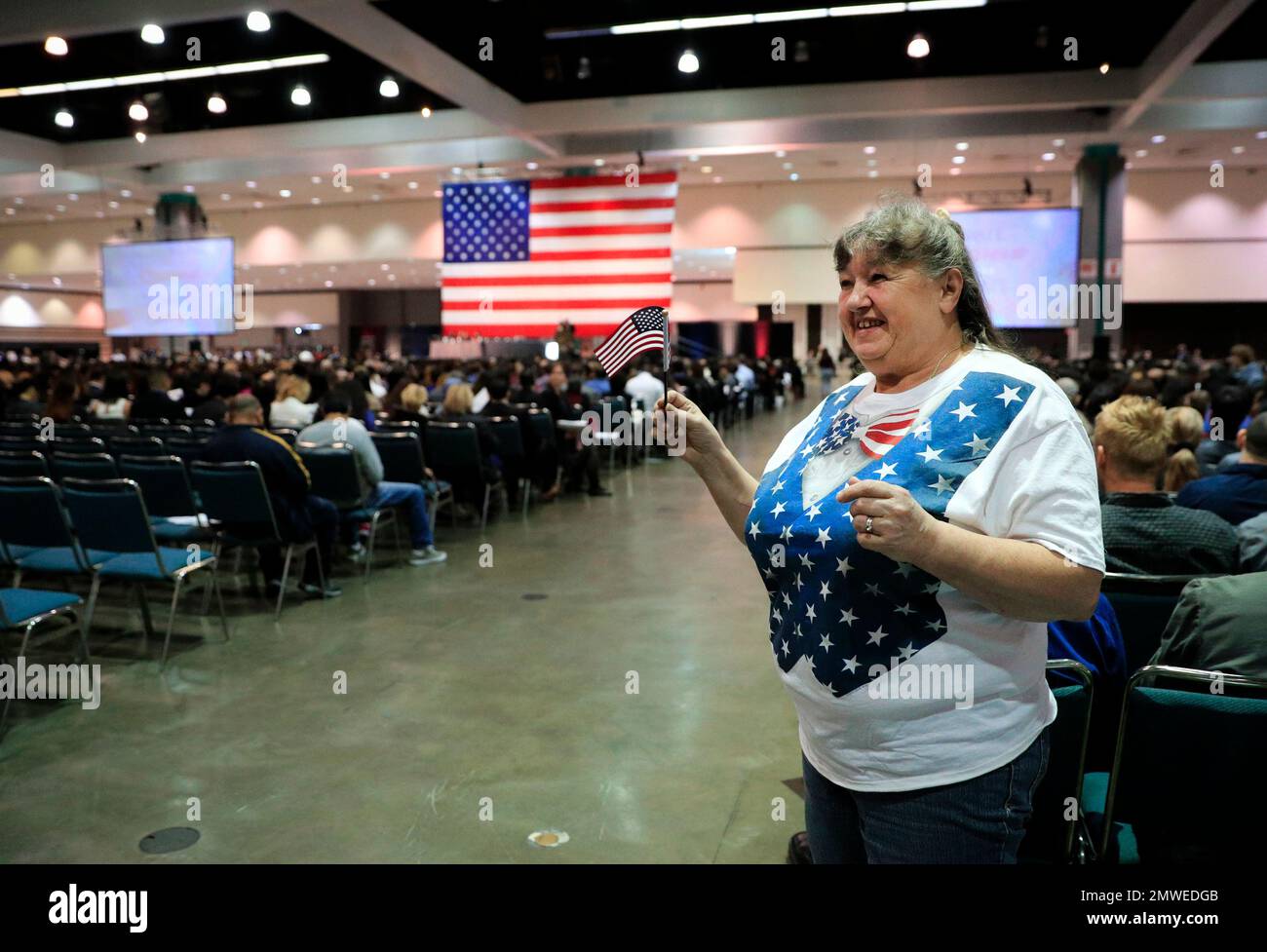 Marian Flemming, 61, who is from Germany originally, waves a U.S flag ...