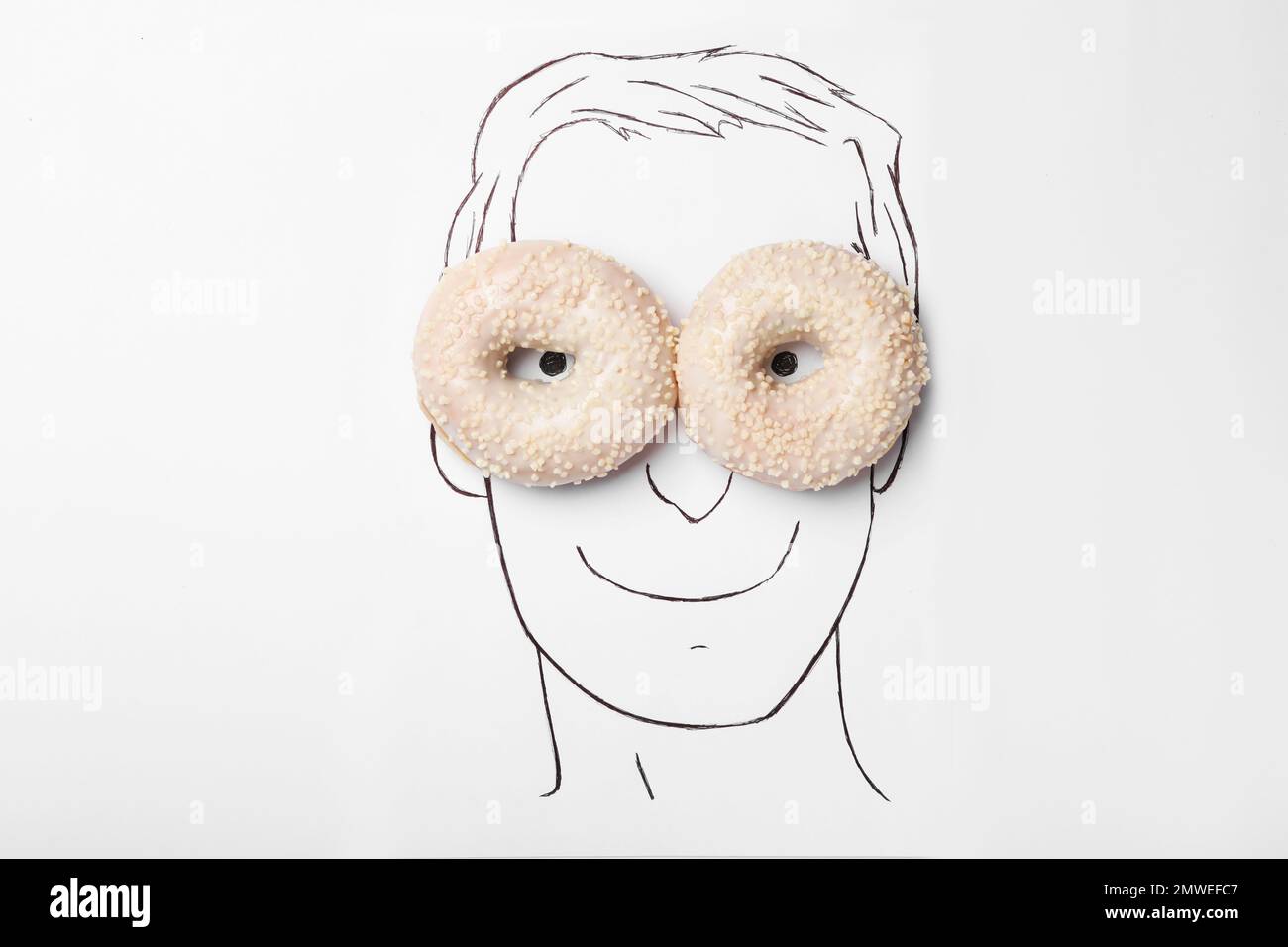 Drawing of man's face and tasty donuts on white background, top view ...