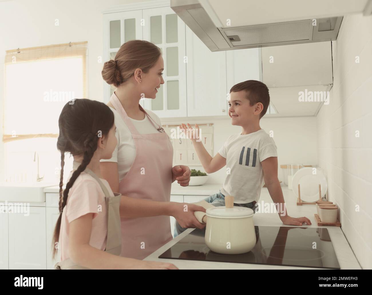 Happy family cooking together in kitchen at home Stock Photo - Alamy