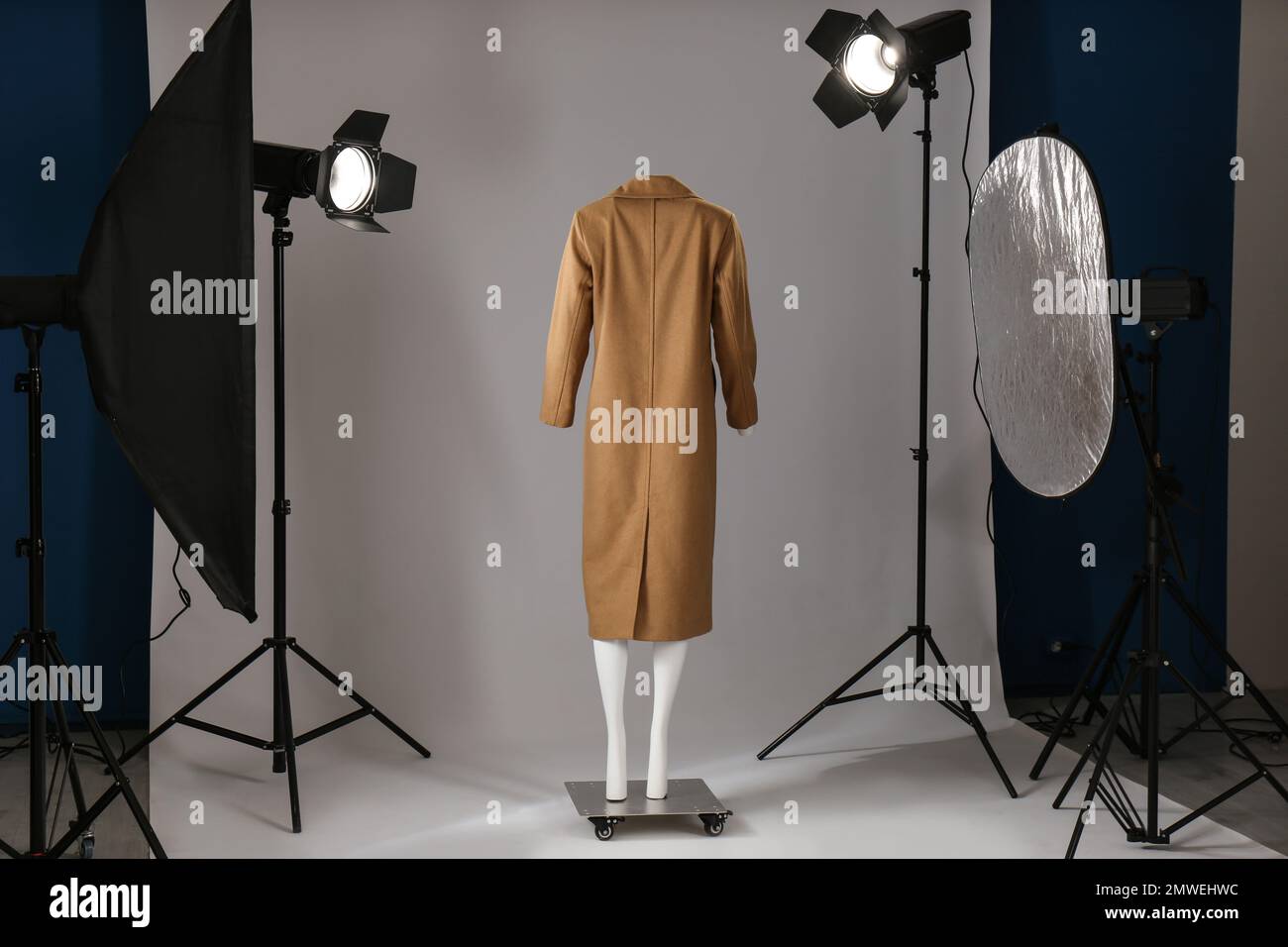 Stylish clothes on ghost mannequin and professional lighting equipment ...