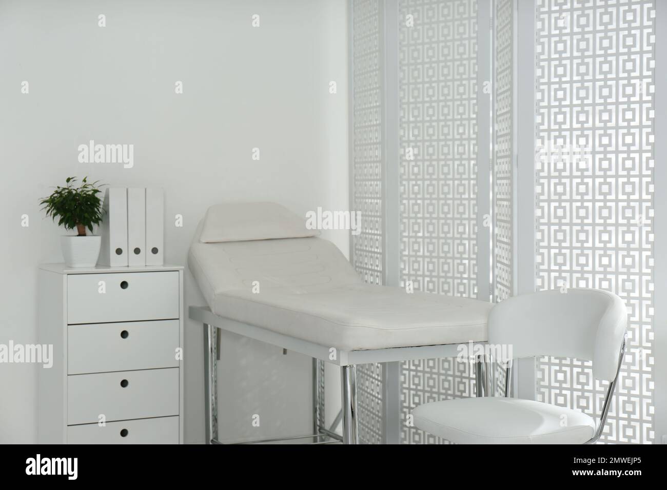 Examination room with modern couch and folding screen in clinic Stock ...