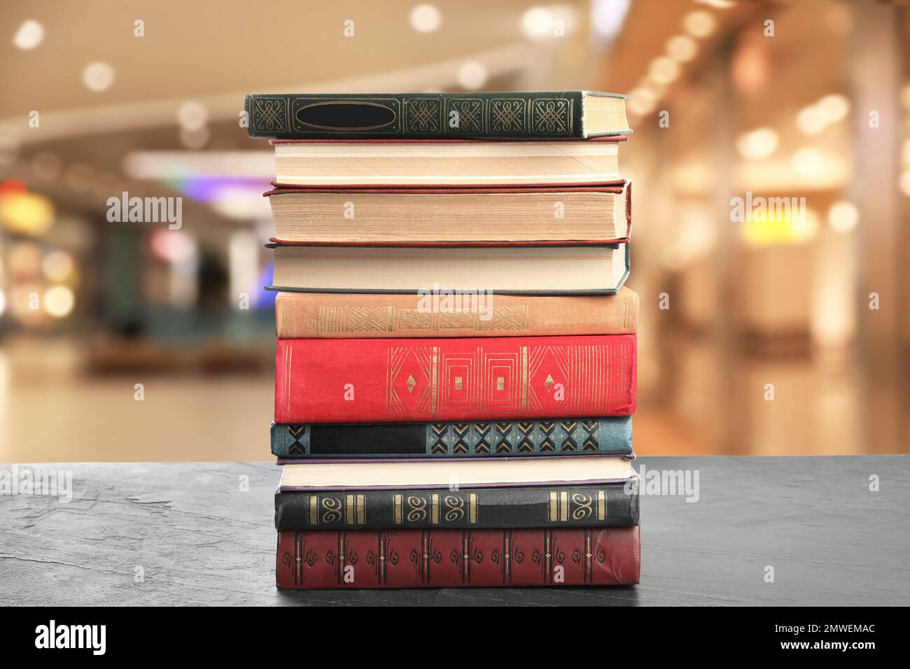 Collection of different books on table against blurred background Stock ...