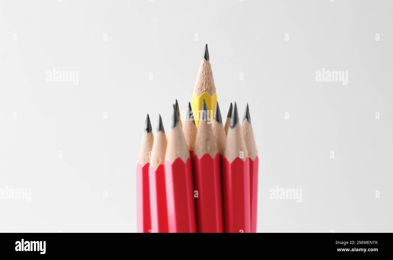 Red pencils and different one on white background Stock Photo - Alamy