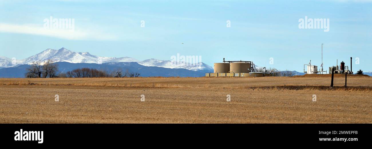 Storage tanks at petroleum extraction site sit on a farm, with the ...