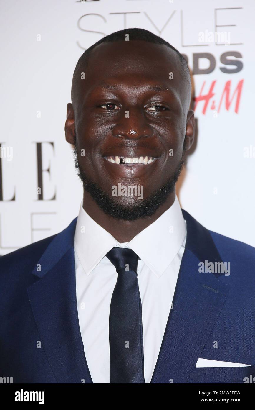 Michael Omari poses for photographers upon arrival at the Elle Style ...