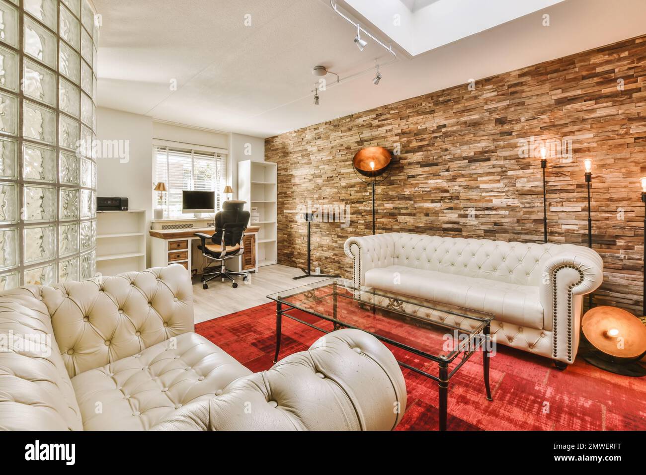a living room with white couches and a red rug on the floor in front of ...