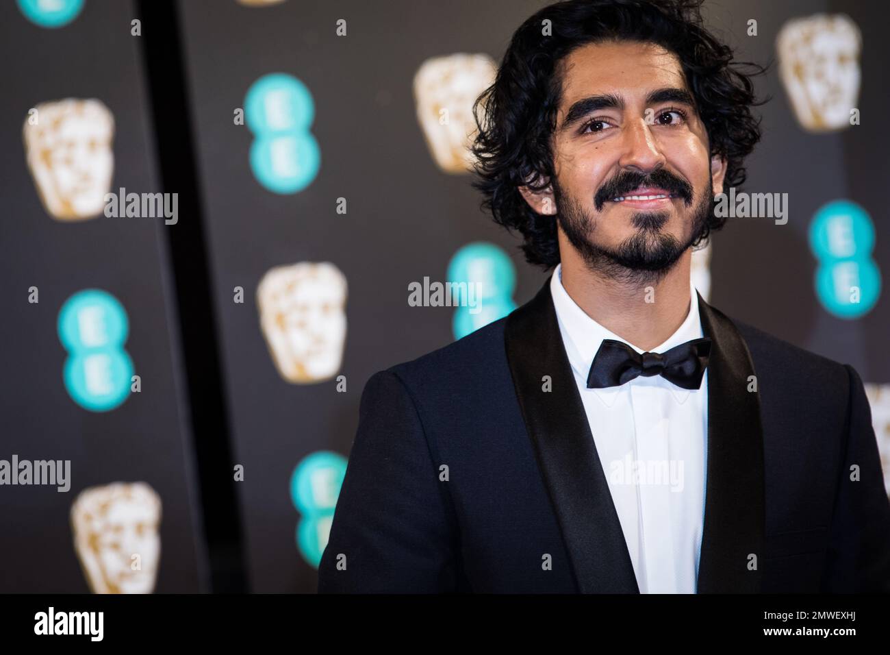 Dev Patel poses for photographers upon arrival at the BAFTA Film Awards ...