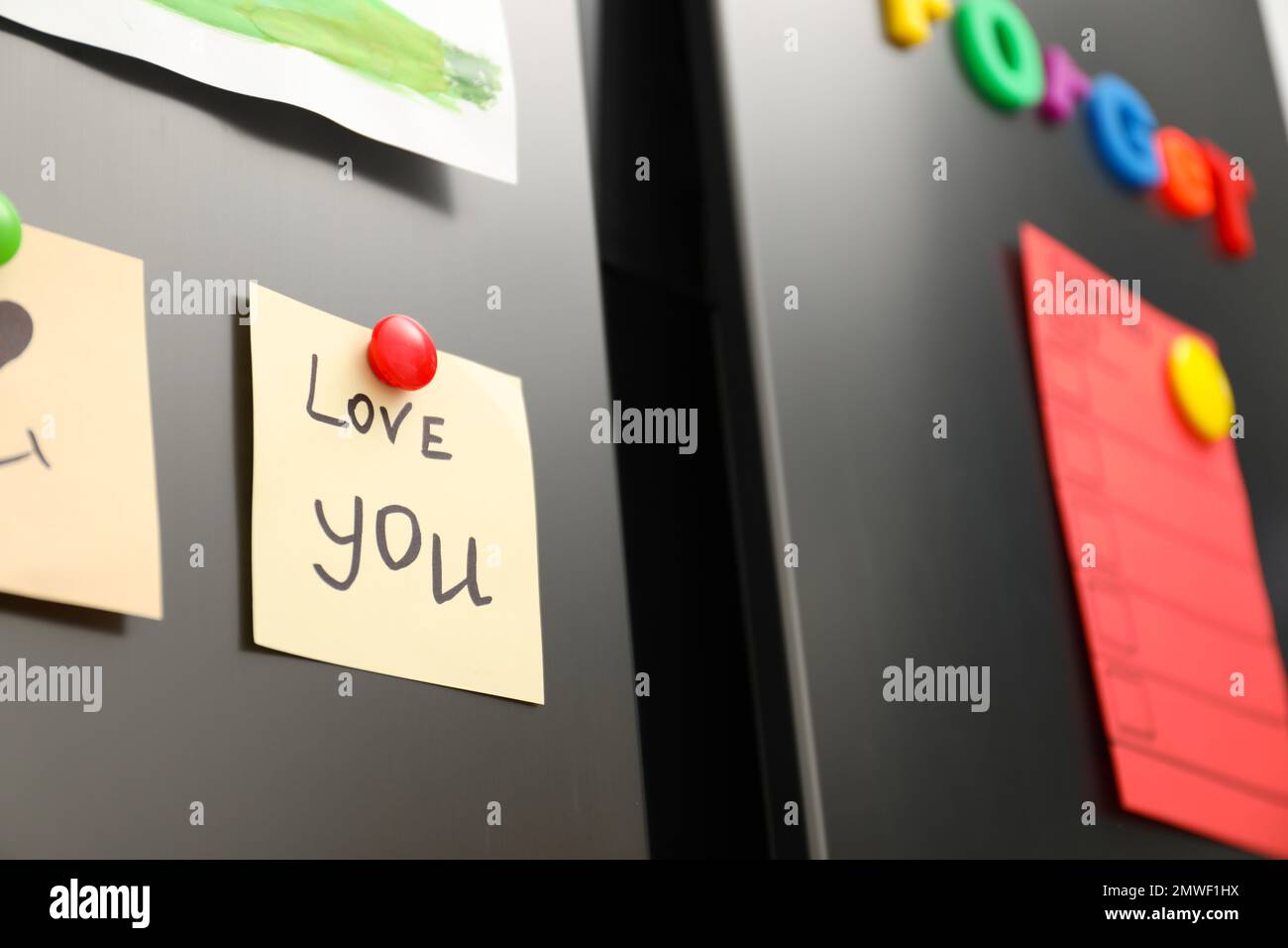 Note with phrase LOVE YOU and magnets on refrigerator, closeup Stock ...