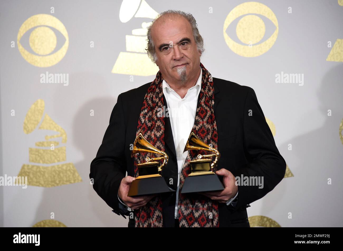 Steve Berkowitz poses in the press room with the awards for best ...