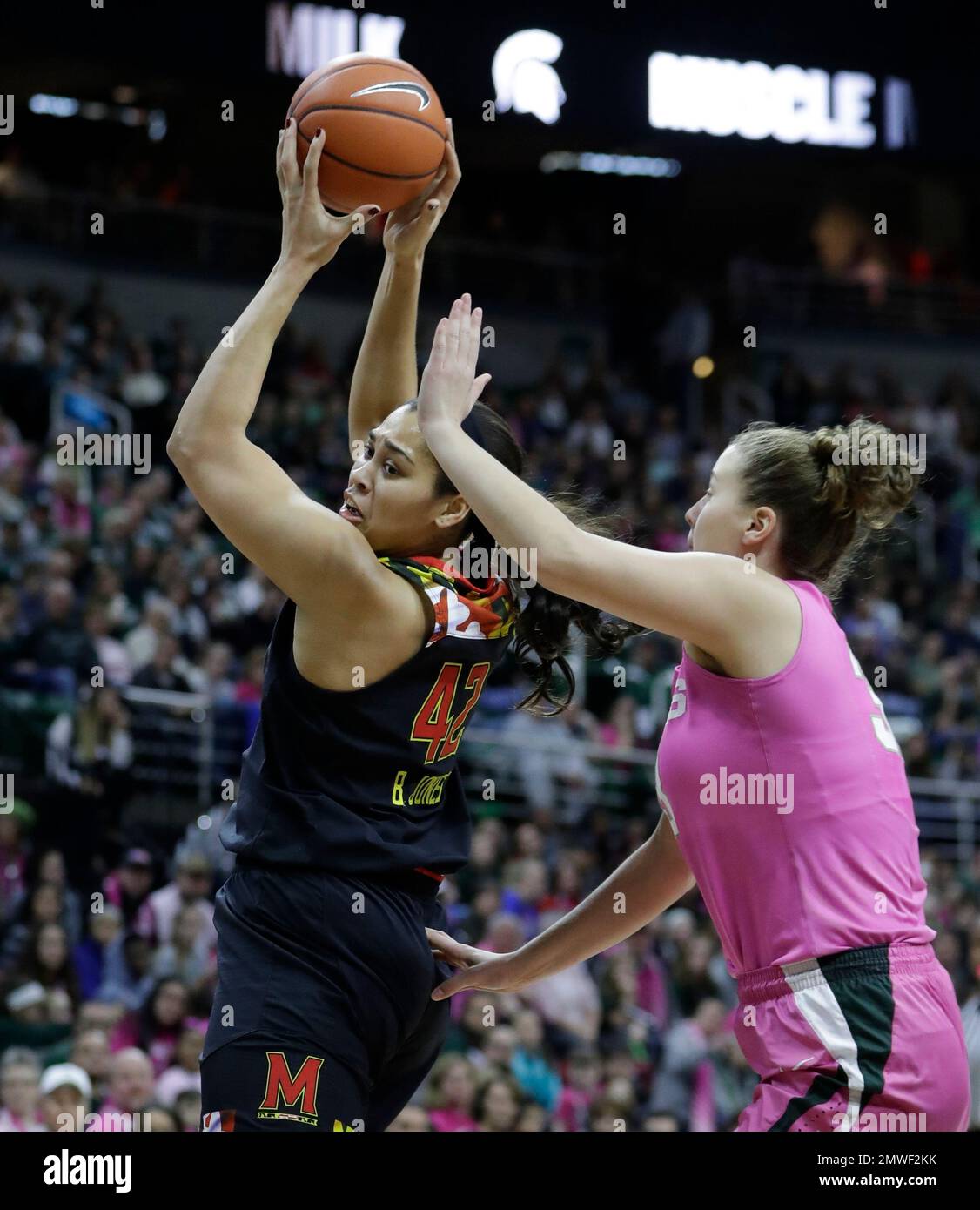 Maryland center Brionna Jones is guarded by Michigan State center Jenna ...