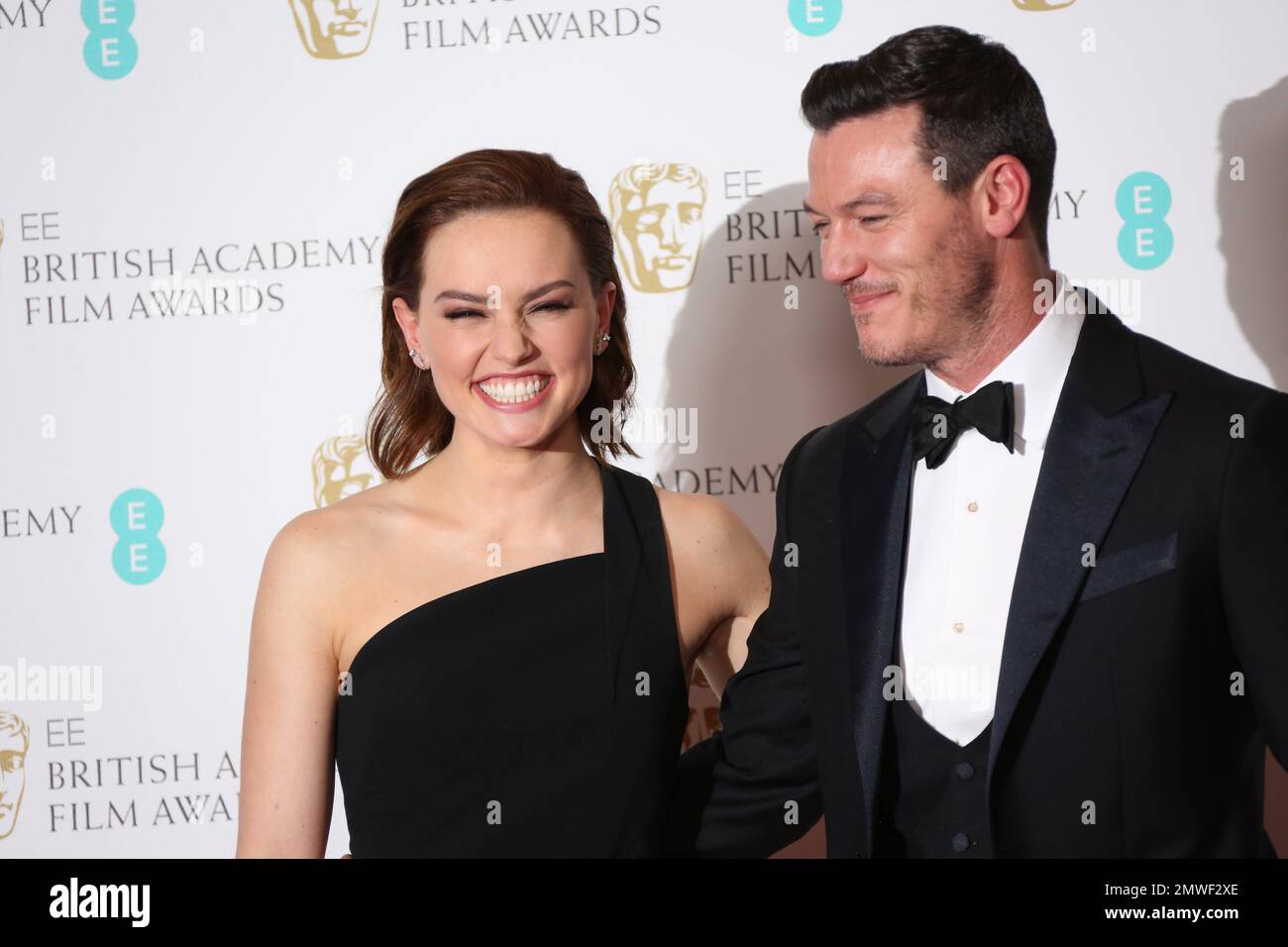 Daisy Ridley and Luke Evans pose for photographers in the press room ...