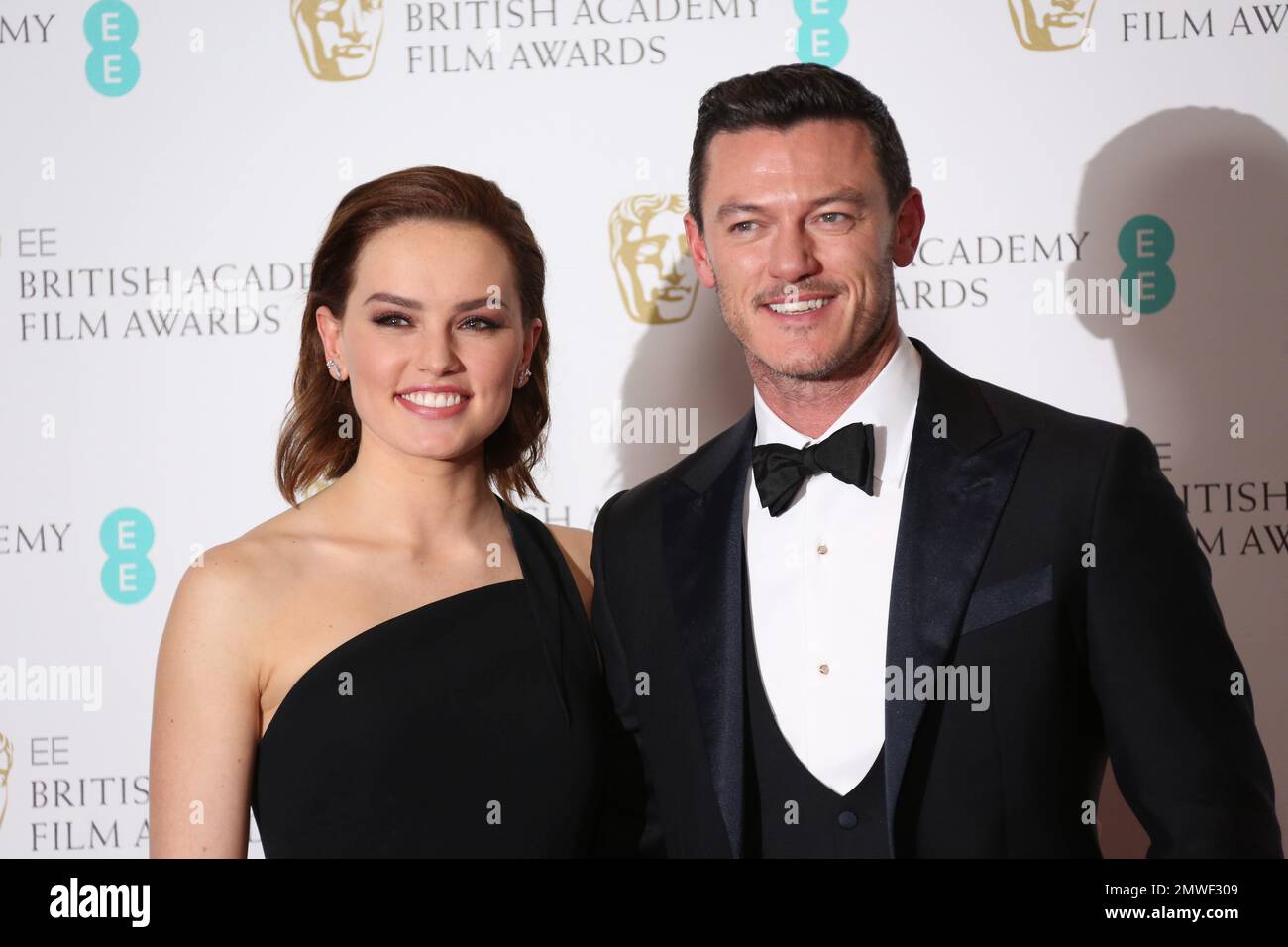Daisy Ridley and Luke Evans pose for photographers in the press room ...