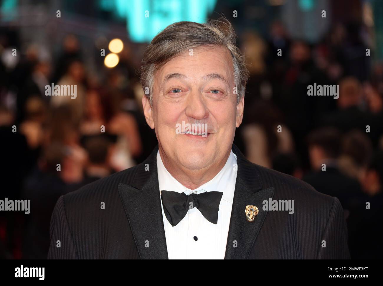 Stephen Fry poses for photographers upon arrival at the British Academy ...