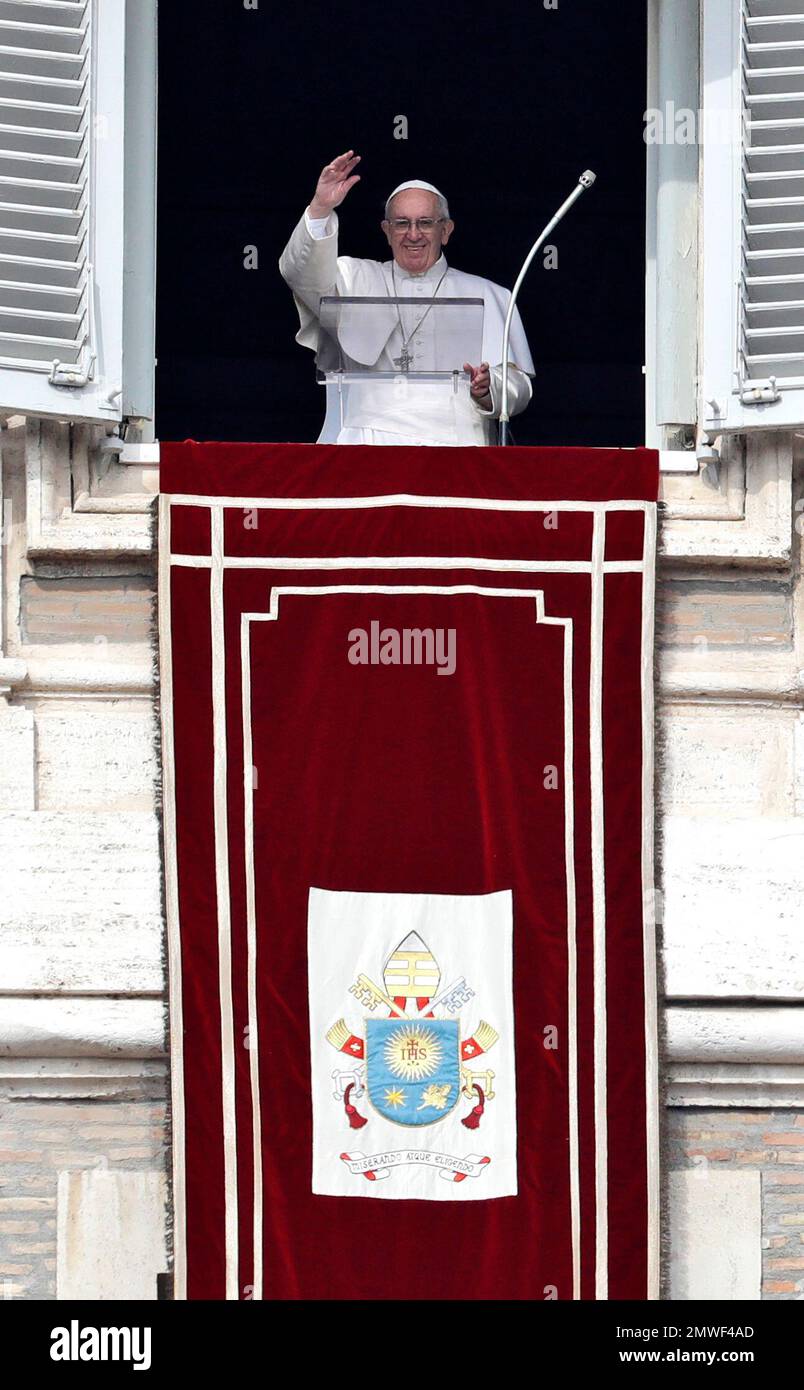 Pope Francis waves to faithful from his studio window overlooking St ...