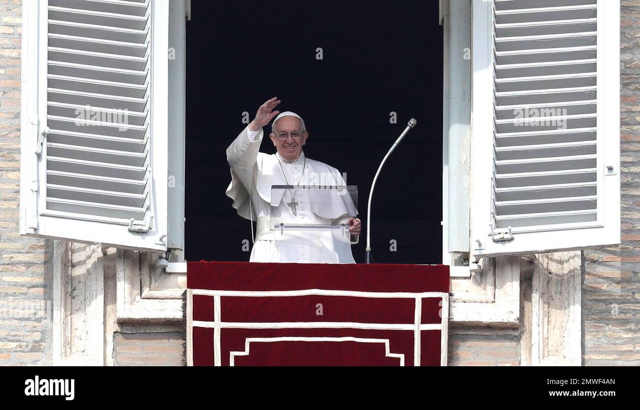 Pope Francis waves to faithful from his studio window overlooking St ...